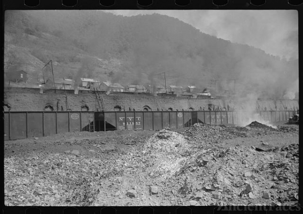 Coke ovens and burning slag heaps make heavy impenetrable...