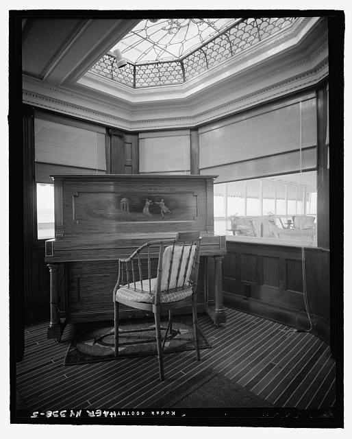 Steinway piano and stained glass clerestory window in...