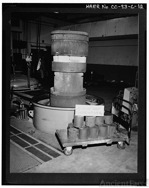 12. VIEW OF DEPLETED URANIUM INGOT AND MOLDS. DEPLETED...