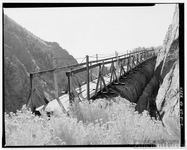 11. Wood stave pipe on metal cradle with wood catwalk,...