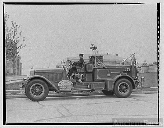 Fire engine. Man at wheel of fire engine