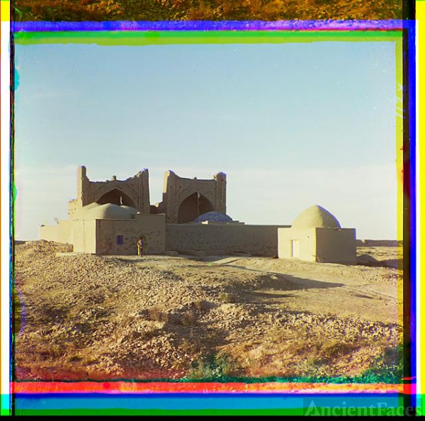 [Walled adobe structure with domes and arches in desert...
