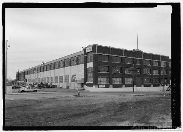 Perspective view. Three-story steel and brick building...