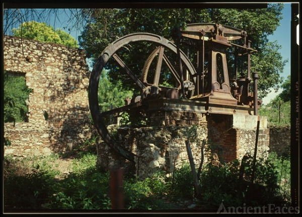 3/4 VIEW LOOKING SOUTHEAST AT STEAM ENGINE AND FLY WHEEL...