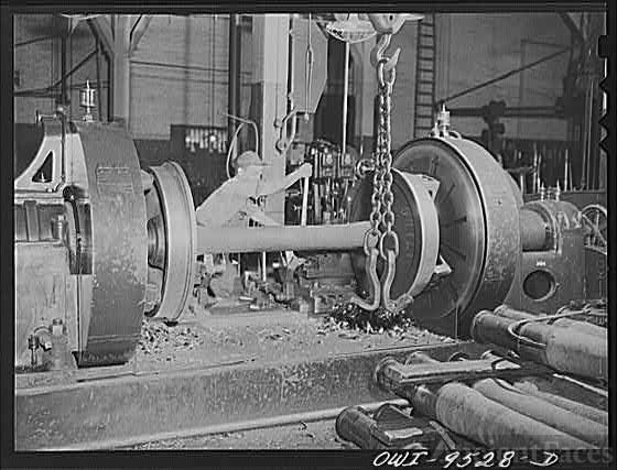 Tulsa, Oklahoma. Repairing railroad wheels in a machine...