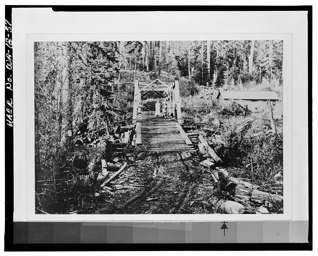 Historic view of timber through howe-truss bridge...