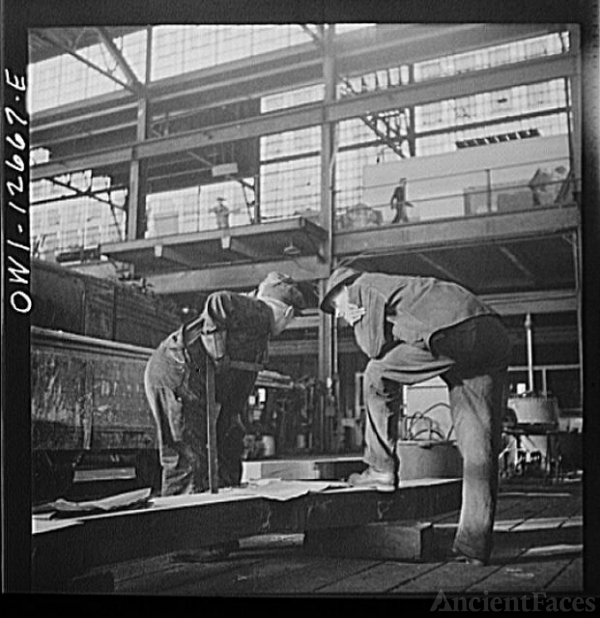 Chicago, Illinois. Workmen studying blueprints in the...
