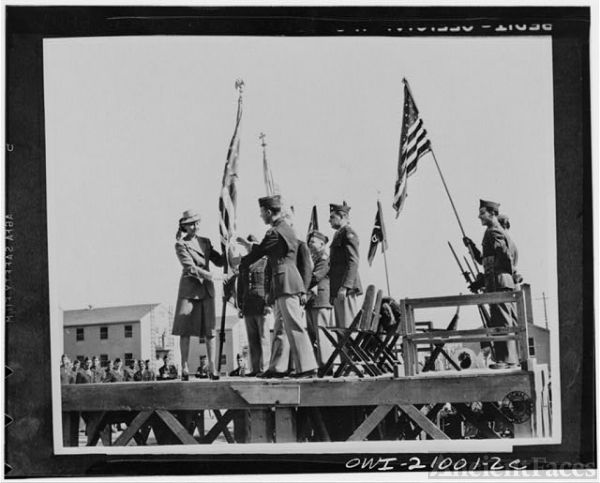 Camp Carson, Colorado. The American flag is presented to...