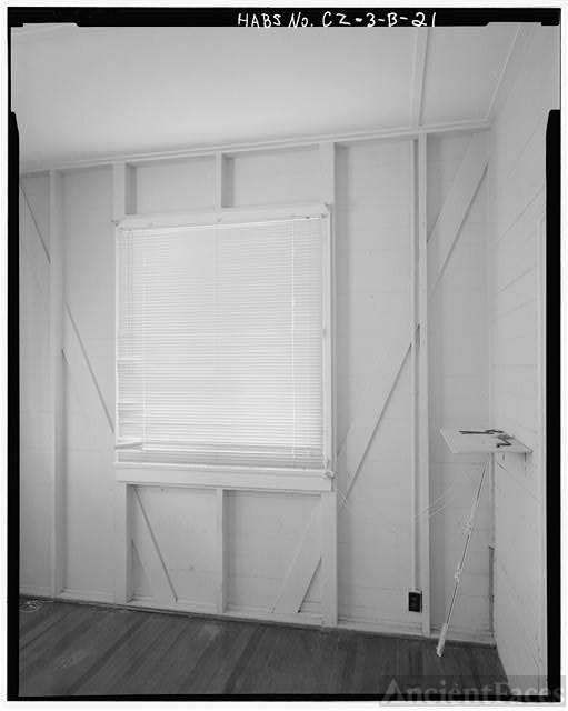 Interior of bedroom showing window and wall framing,...