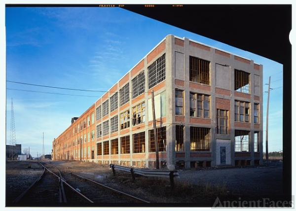 WEST FACADE. THREE-STORY BRICK AND STEEL BUILDING WITH...