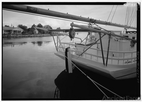 30. DETAIL OF STERN SHOWING HELM AND DAVITS AND BUMPER...