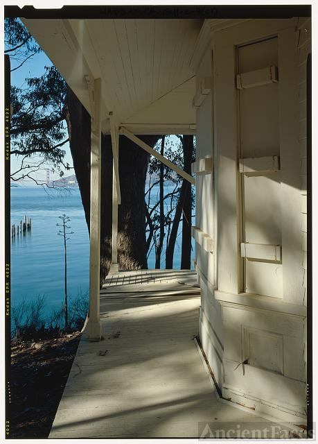 View of porch with bay window and pier in background from...
