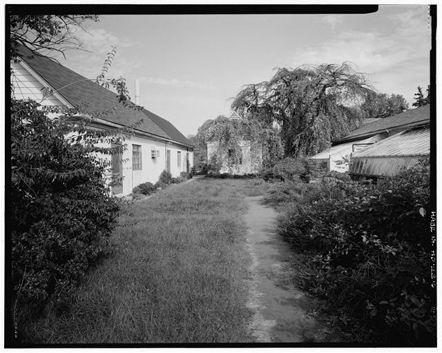 6. VIEW EAST. ALLEY BETWEEN HEADHOUSE (BUILDING 4) AND...