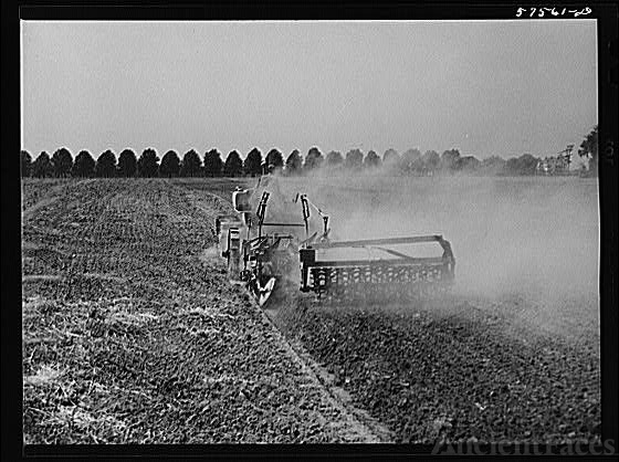Harrowing field before planting. Starkey Farms,...