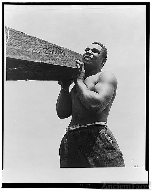 Negro laborers carrying and laying railroad ties for a...