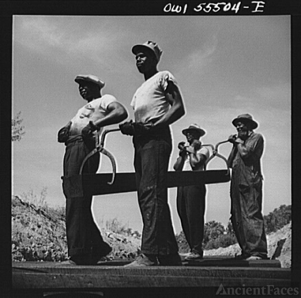 Negro laborers carrying and laying railroad ties for a...