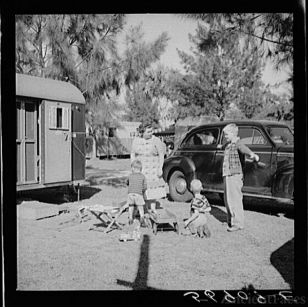 Children and their mother outside their trailer home....
