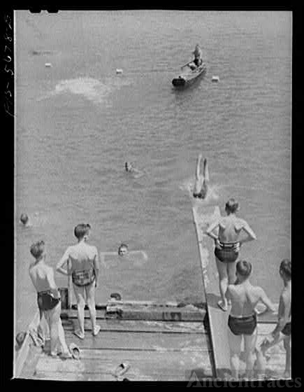 Boys swimming and boating at a Boy Scout camp. Florence...