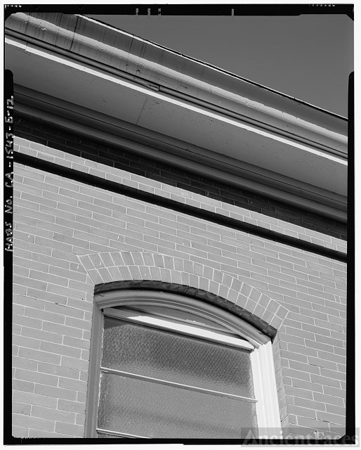 Detail of arched window and eaves molding on west...