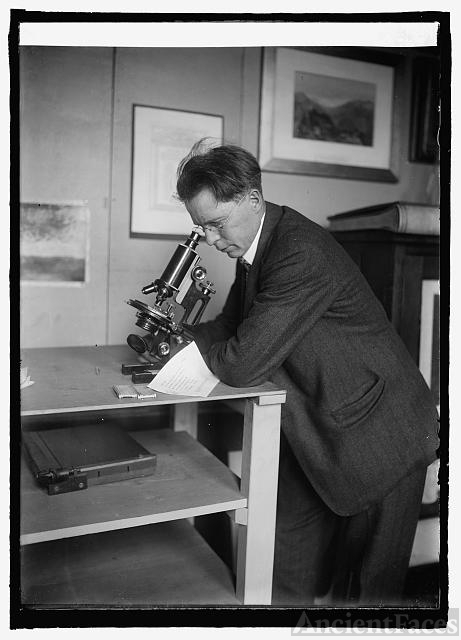 R.P. Tolman at museum, with letter in eye of needle,...