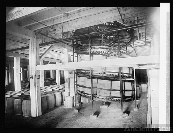 Spiral gravity boiler conveyor for handling barrels and...