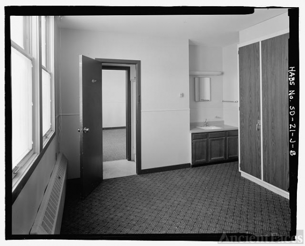 8. Interior view of Room 127 looking at sink and door to...